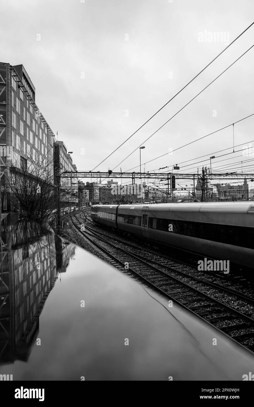 a train on railway in city during a rainy day Stock Photo - Alamy