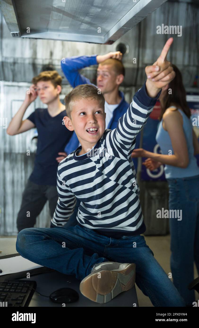 Child boy saw the key to solve the puzzle to get out of the escape room ...