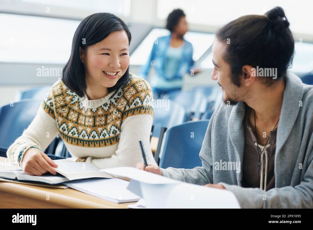 Friendly classroom banter. a two university students talking to each ...