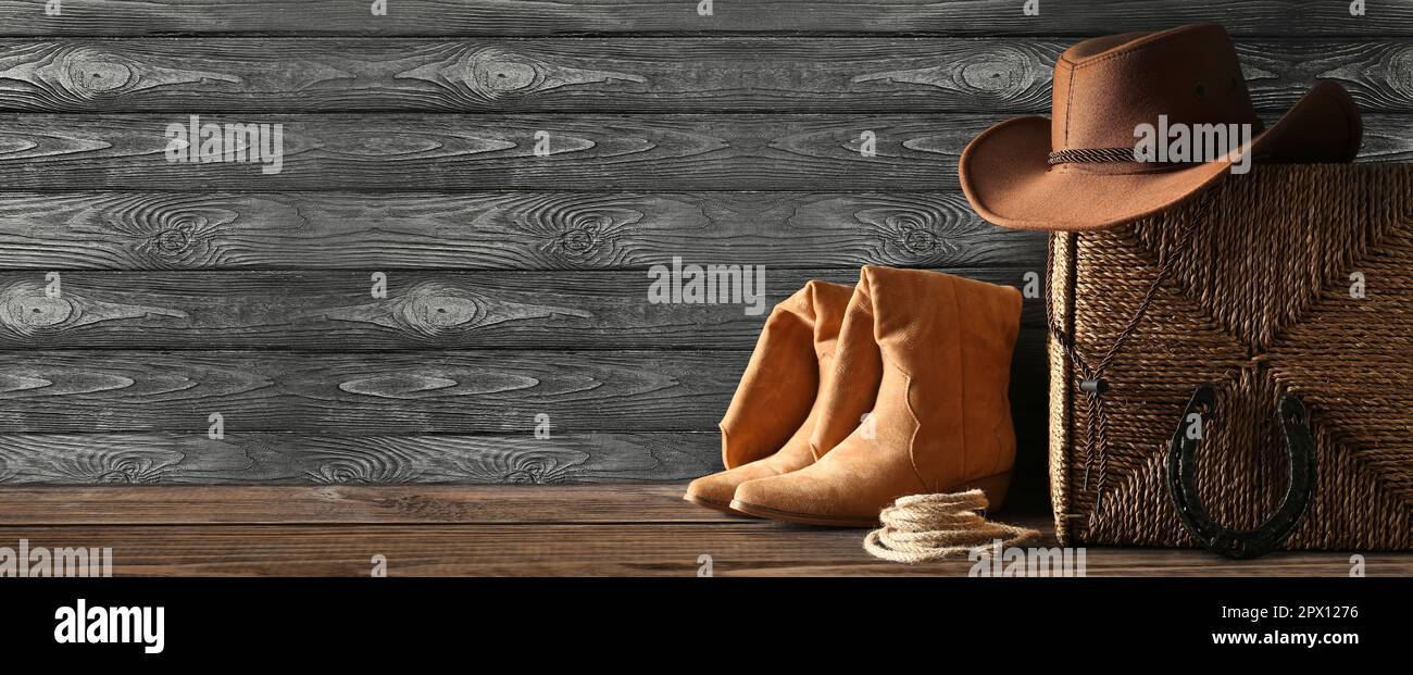 Cowboy hat with boots, box, horseshoe and lasso on dark wooden ...