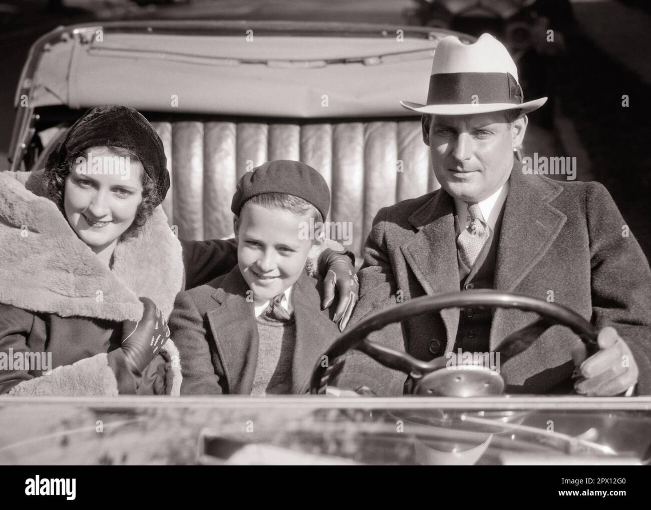1930s SMILING FAMILY FATHER MOTHER SON RIDING TOGETHER LOOKING AT ...