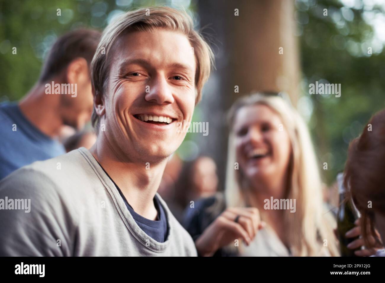 Enjoy an outdoor event. Portrait of a happy young man enjoying an ...