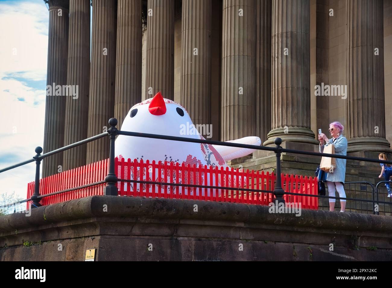 Liverpool, UK. 29th Apr, 2023. A woman take a photo of an illuminated ...