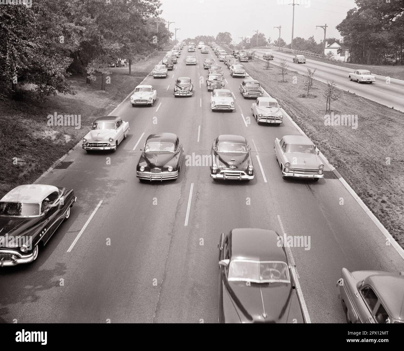 1950s HEAVY ON COMING CAR TRAFFIC ON FOUR LANES OF EIGHT LANE DIVIDED ...
