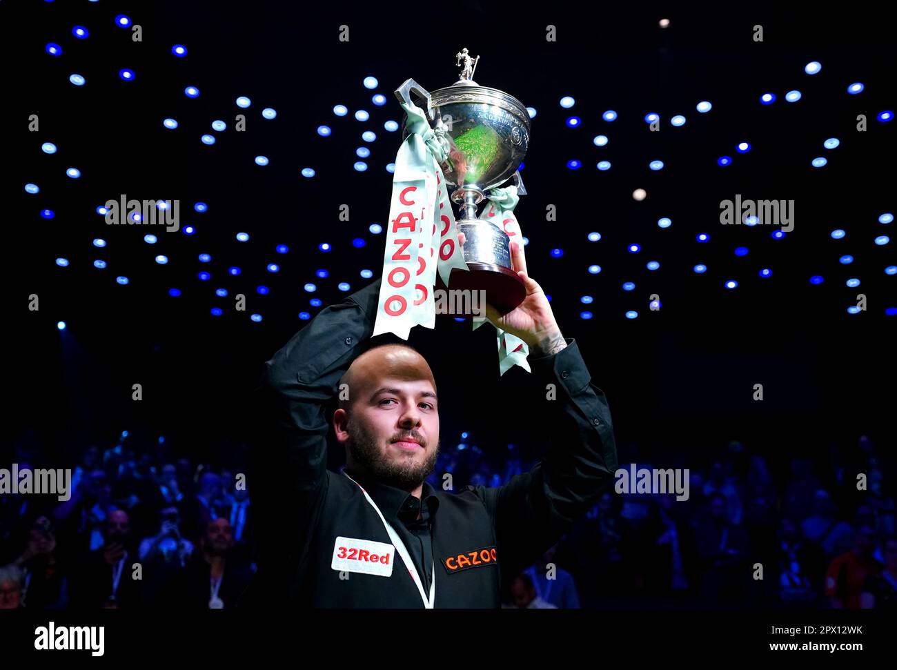 Luca Brecel celebrates with the trophy after beating Mark Selby to win ...