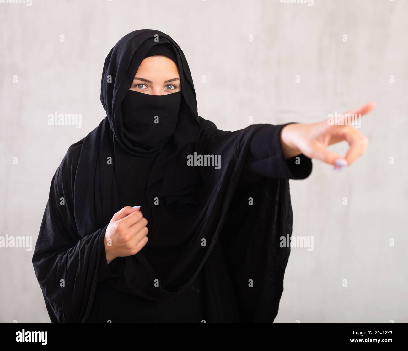 woman with her face covered by burka points her hand to side Stock ...