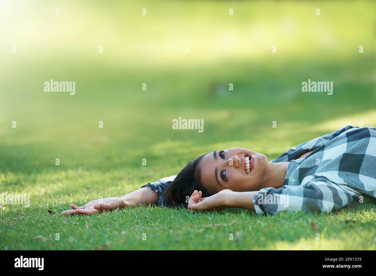 Her relaxing day in the park. Young woman relaxing in the park Stock ...