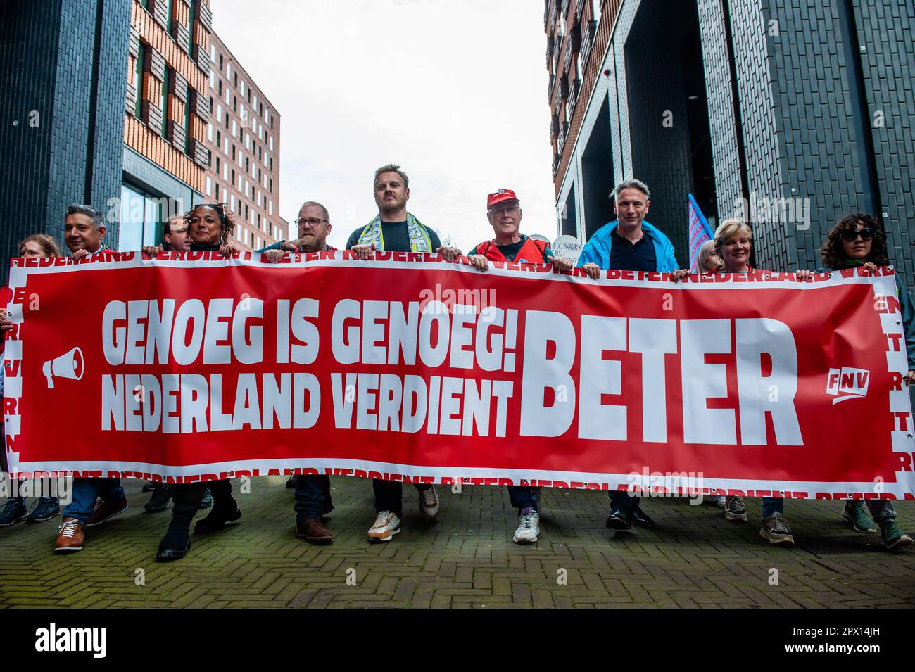 People are marching behind the principal banner that says Enough is ...