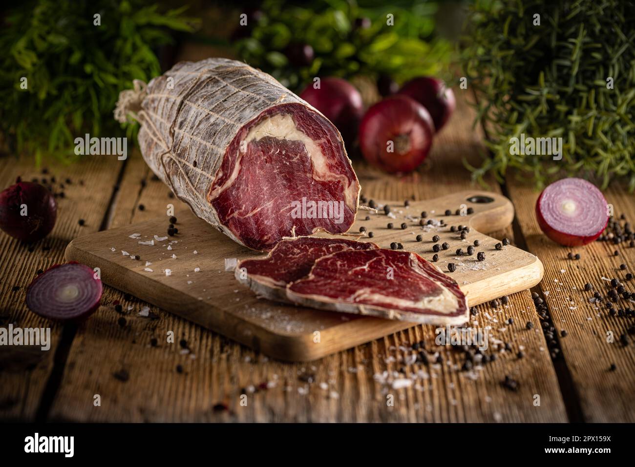 Dried and smoked beef in noble mold coat on wooden background Stock ...