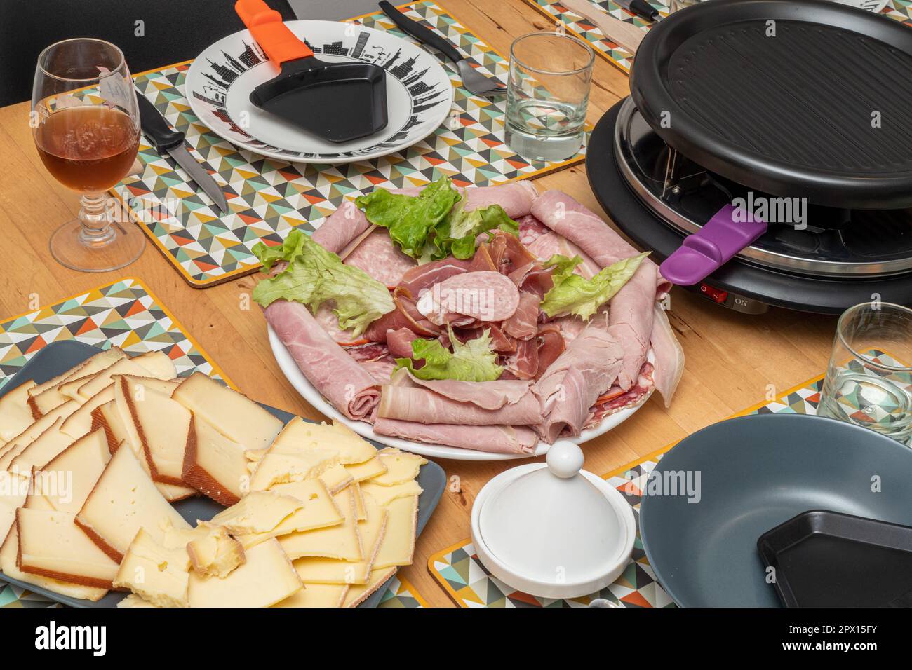 Raclette cheese and meat, a french tradition Stock Photo - Alamy