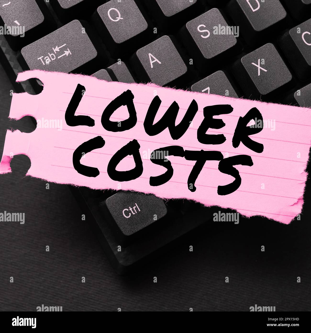 Conceptual caption Lower Costs, Word Written on the business sets low ...