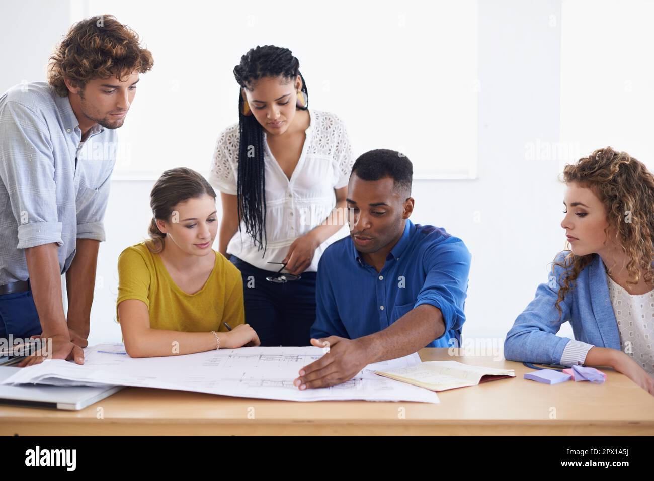 Together theyll achieve the best results. A group of young coworkers ...