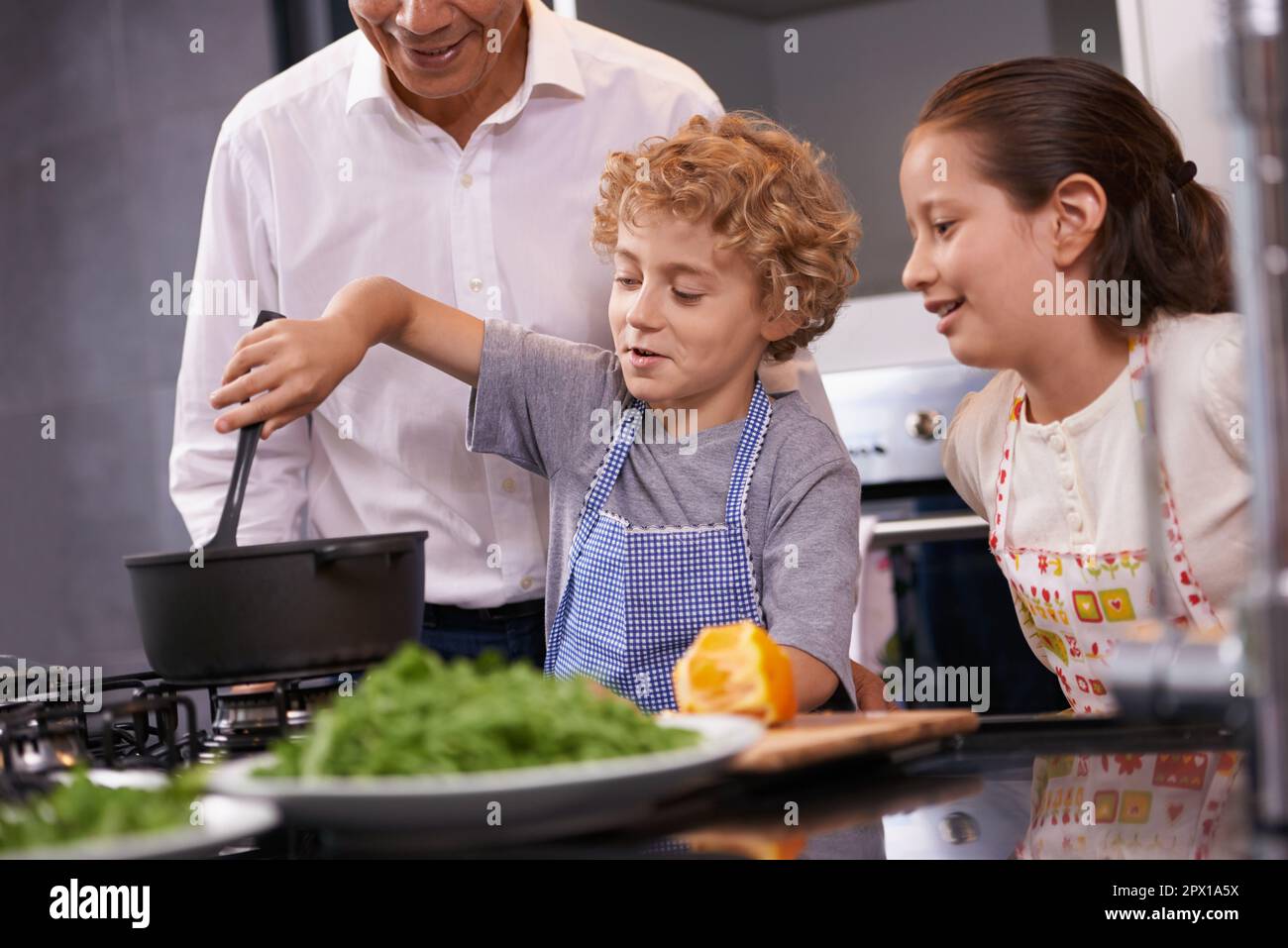 Chef in the making. A brother and sister helping to make dinner at ...