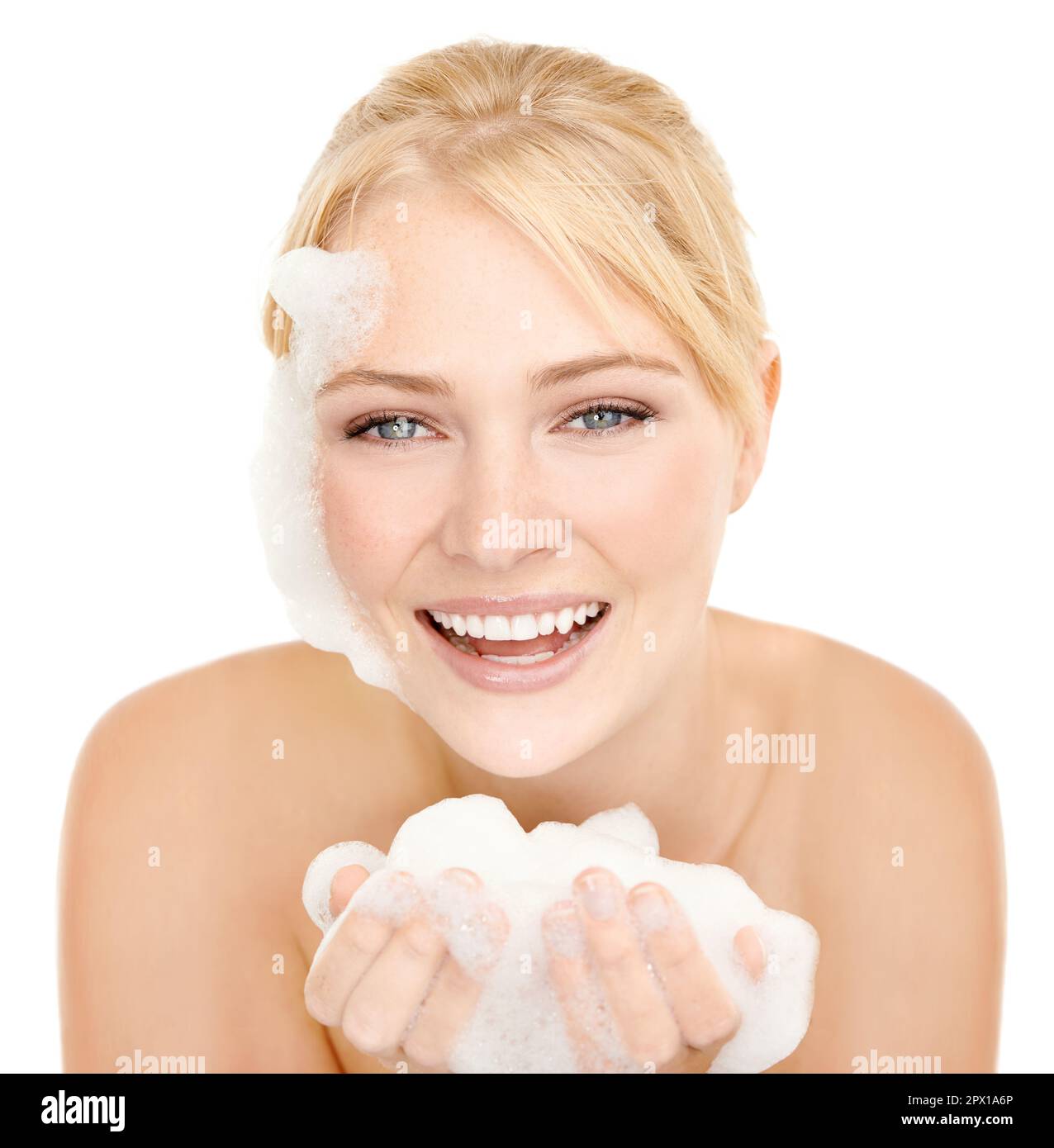 Beautiful clean skin. Studio shot of a beautiful young woman cleansing ...