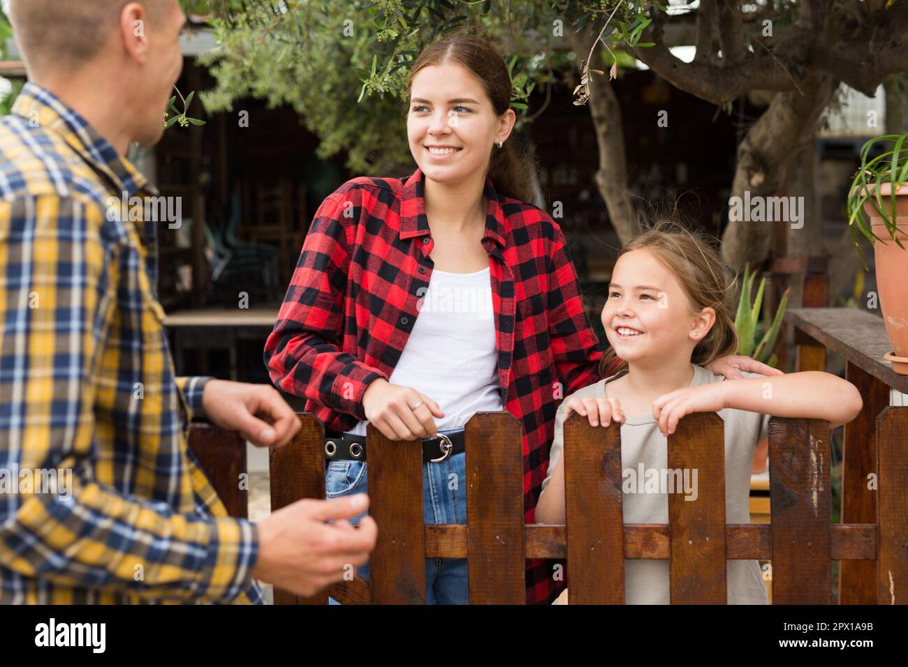 Farm neighbors talk at border in village Stock Photo - Alamy