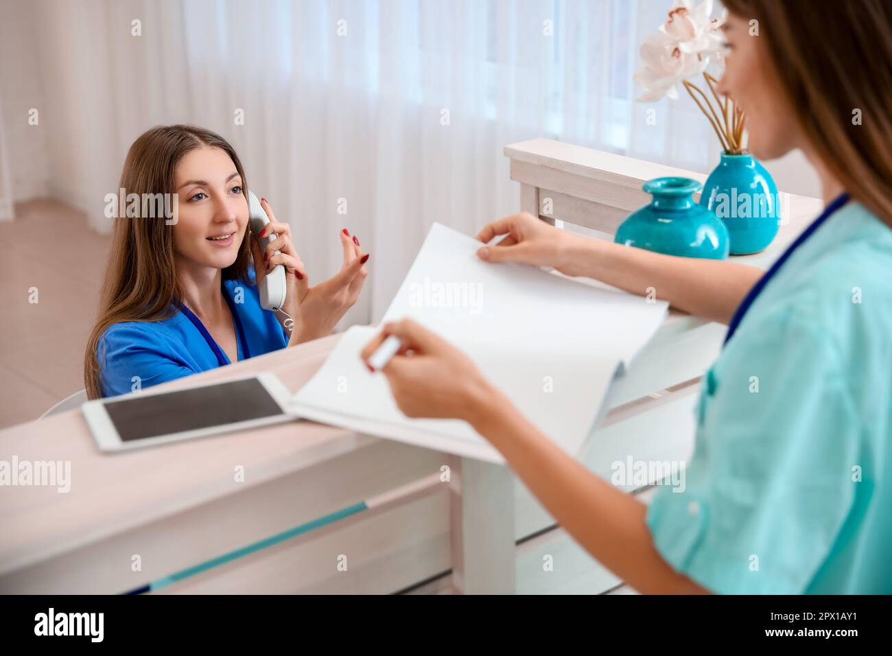 Female medical assistants working in clinic Stock Photo - Alamy