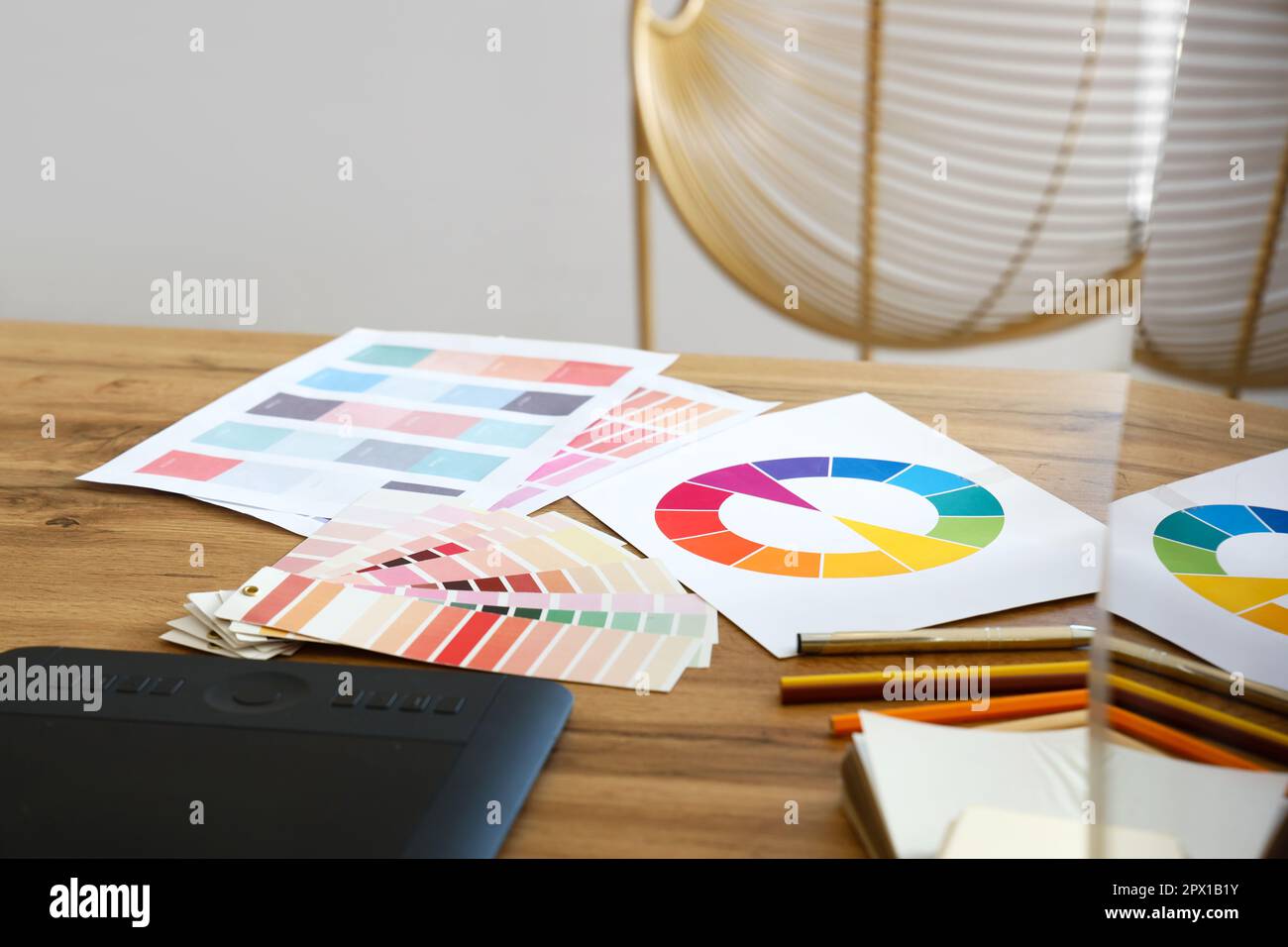 Paint color palettes on graphic designer's table in office, closeup ...