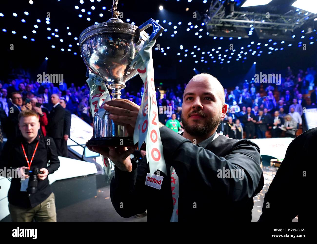 Luca Brecel celebrates with the trophy after beating Mark Selby to win ...