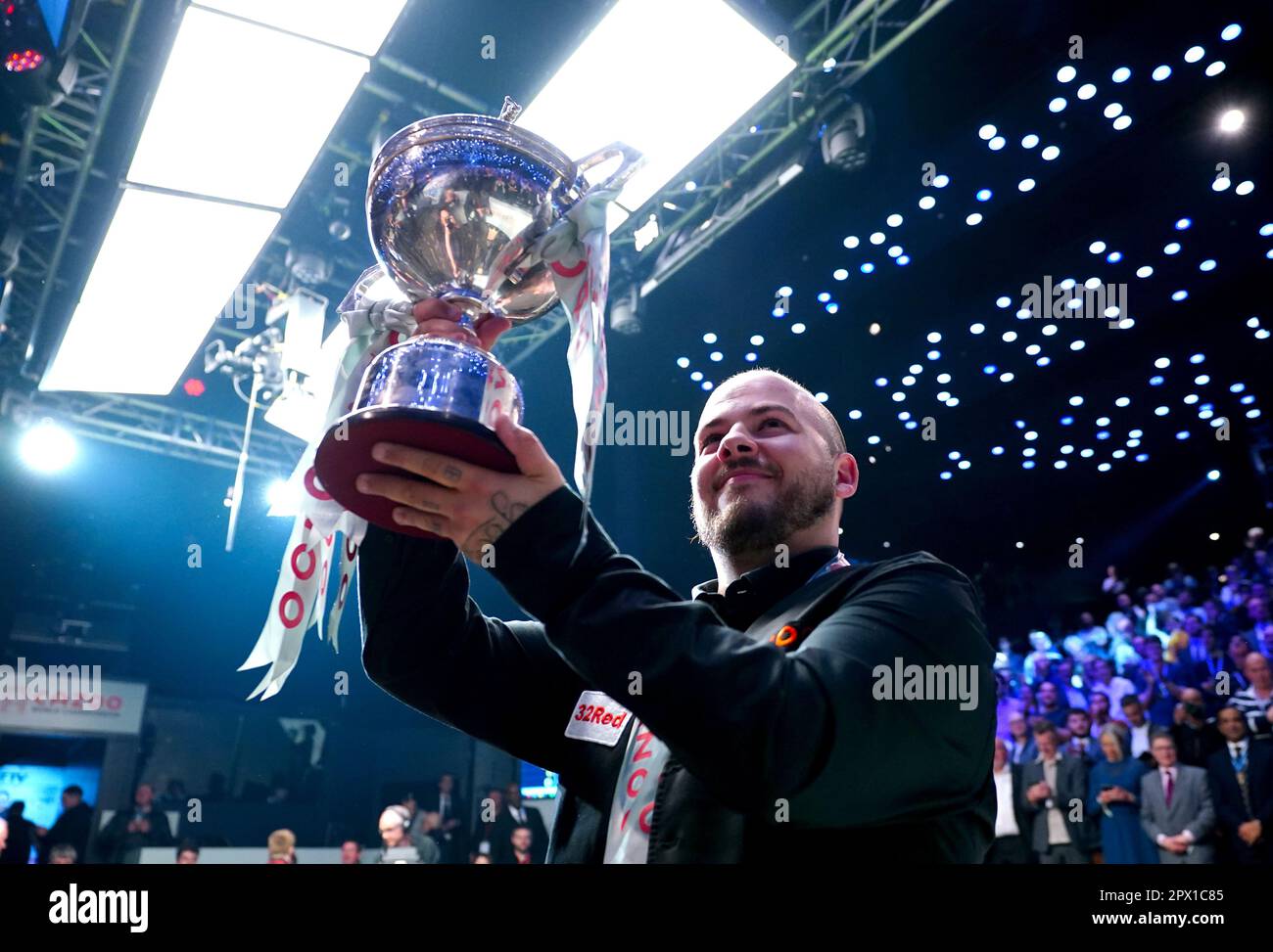 Luca Brecel celebrates with the trophy after beating Mark Selby to win ...