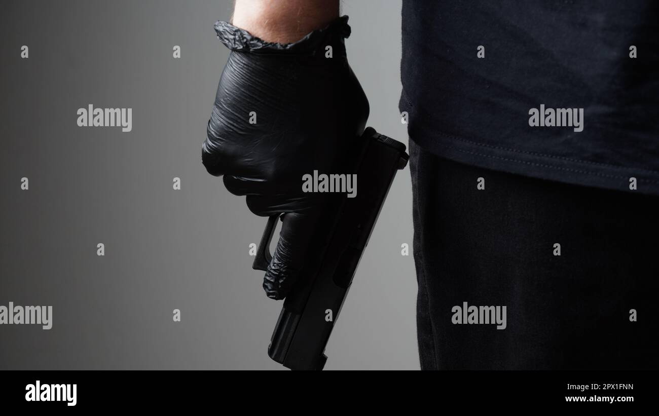Handgun in gunman hand. A man ready to protect himself from bad people ...
