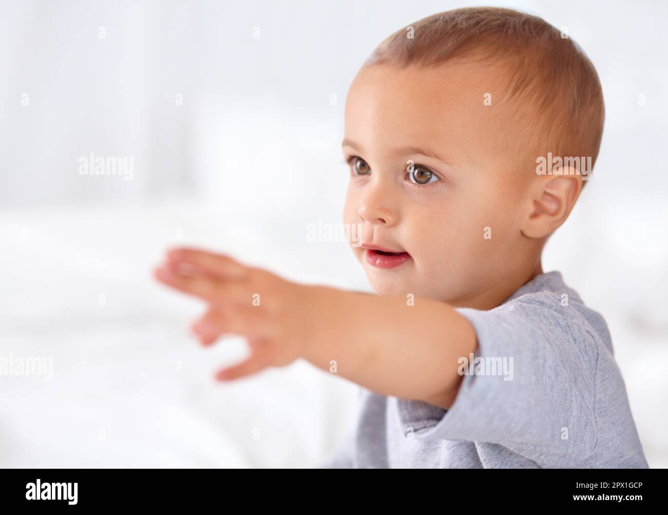 Fascinated by his surroundings. Image of a little baby boy reaching out ...