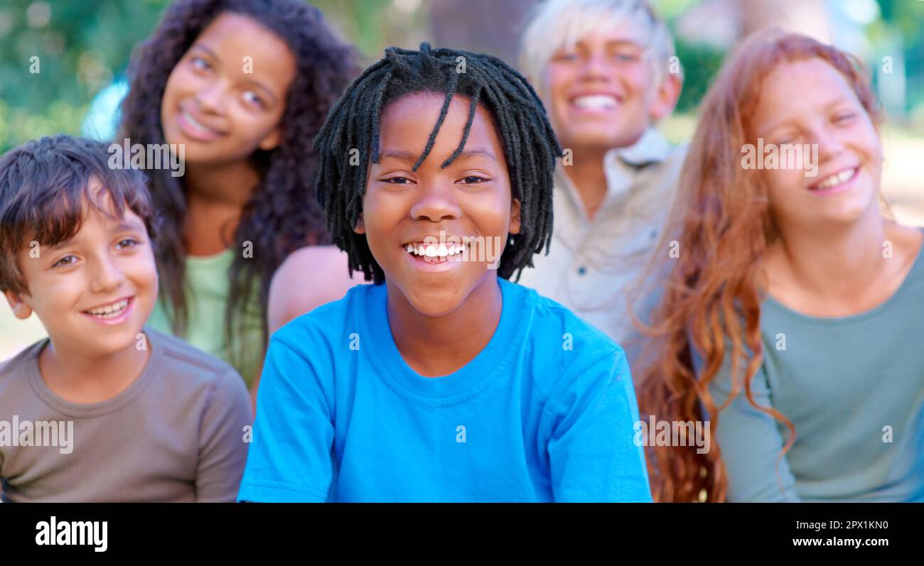 Summer camp fun. A group of happy kids smiling at the camera while ...