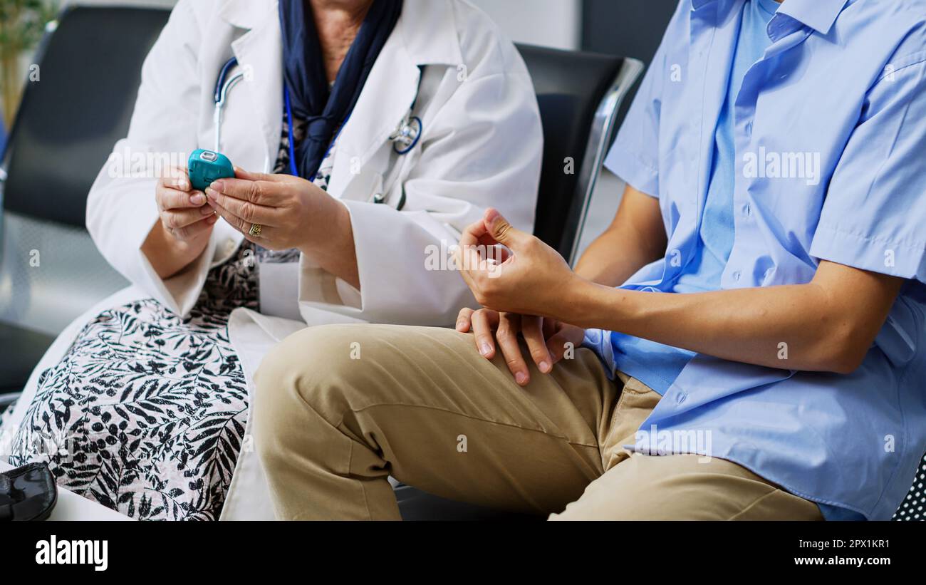 Senior medic measuring insulin level and glucose using glucometer ...