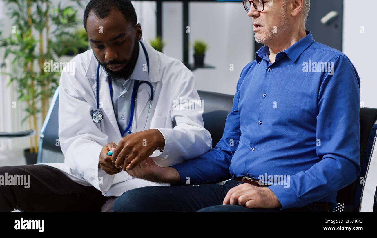 Doctor measuring patient insulin and glucose level using glucometer ...