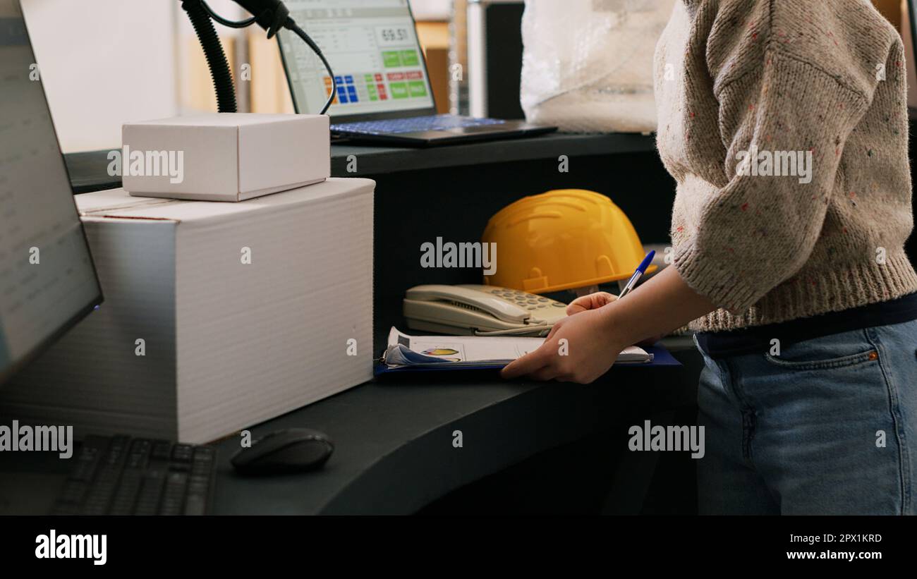 Diverse colleagues working on logistics in storage room, inspecting ...