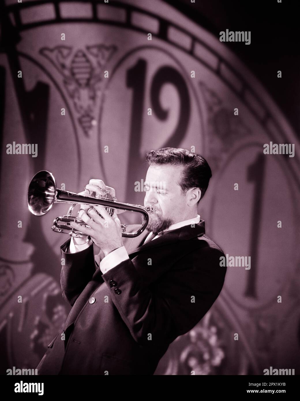 1960s MAN PLAYING A TRUMPET IN FRONT OF A CLOCK FACE ABOUT TO STRIKE ...