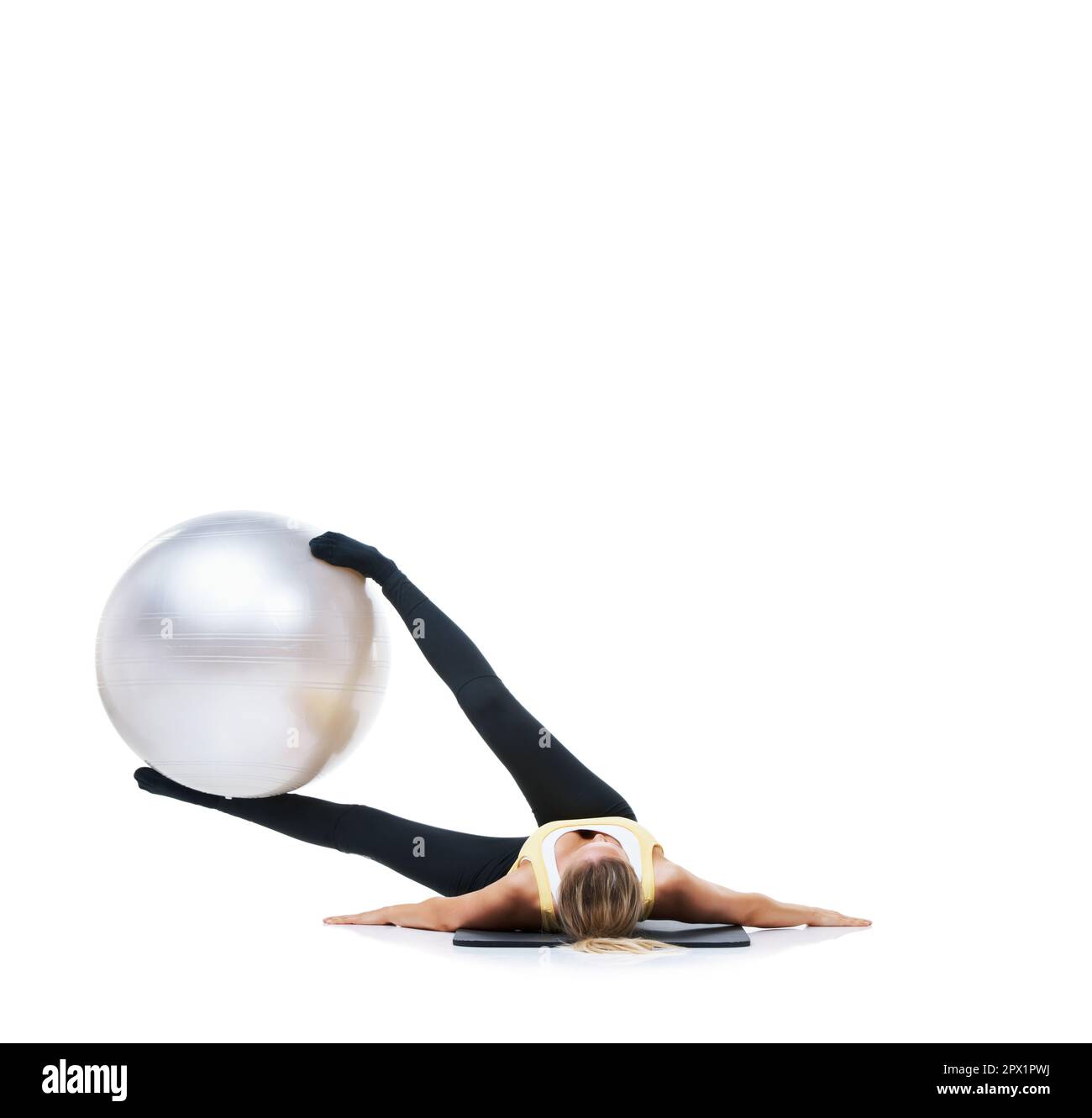 Balance is key. a female holding an exercise ball up with her legs ...