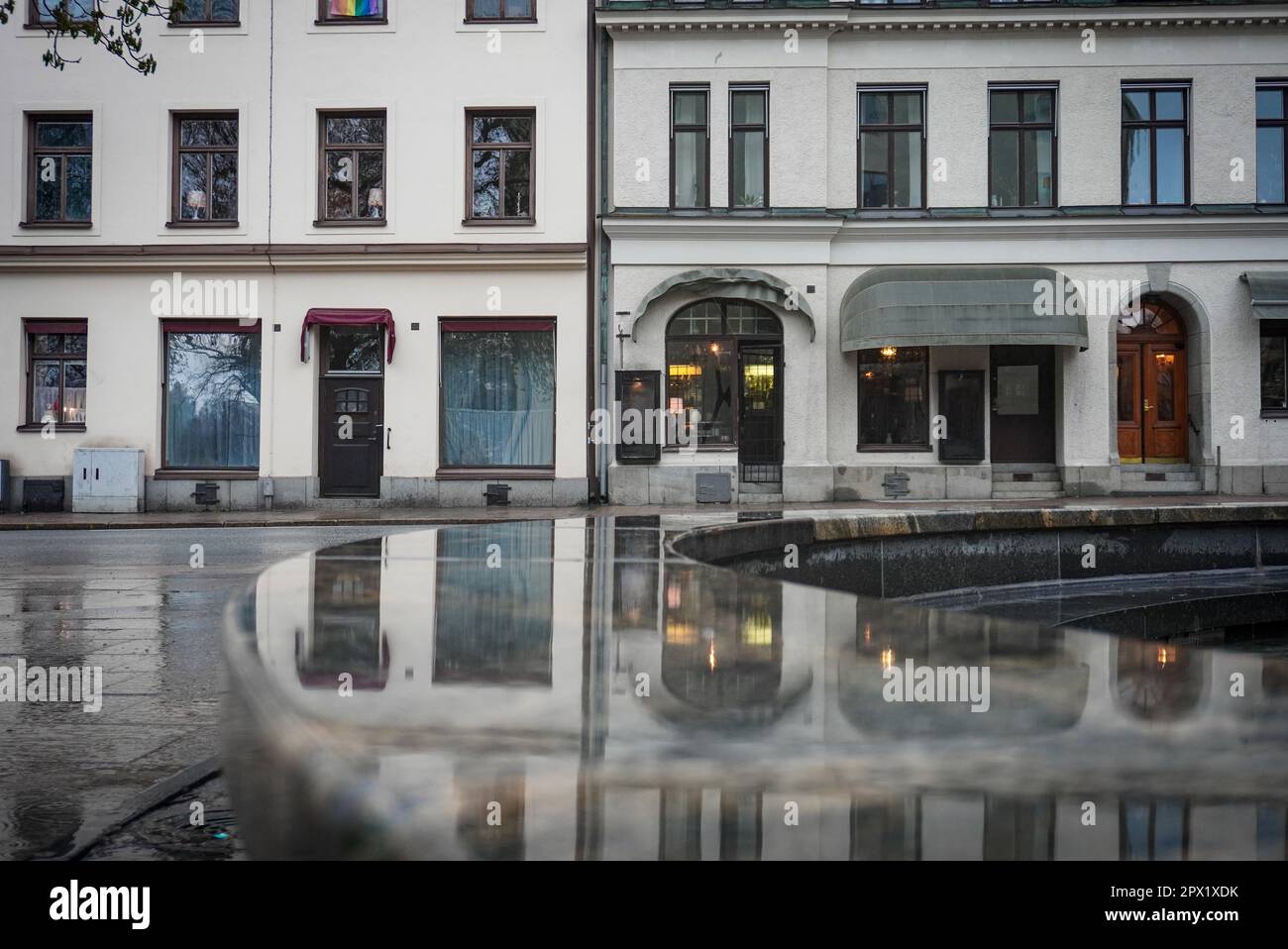 Reflection in stone structure in front of a residential building Stock ...