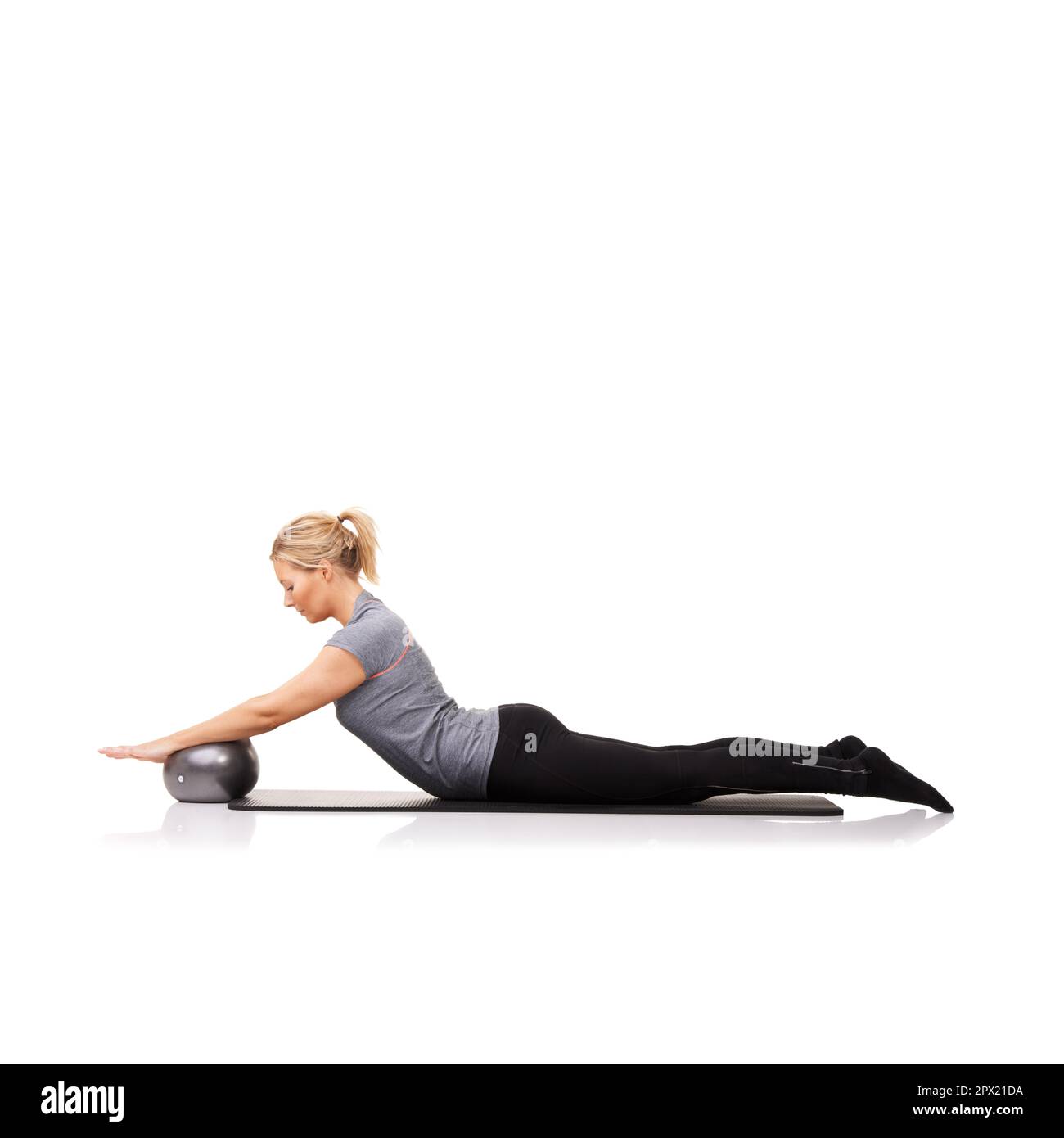 Arching her back and forcing it down. A young woman using an exercise ...