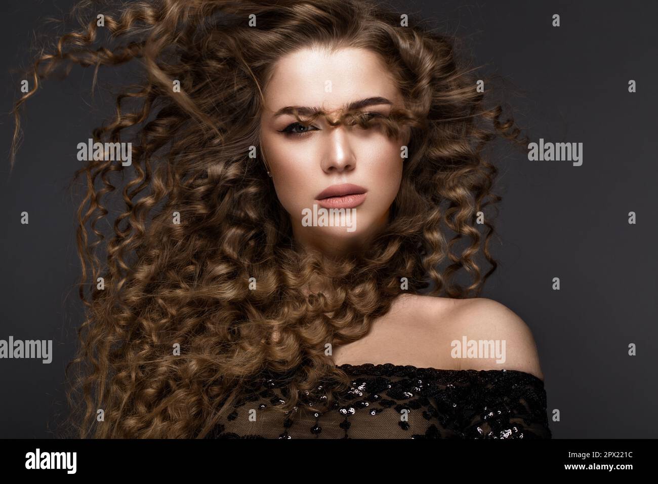 Beautiful brunette girl in move with a perfectly curly hair, and ...