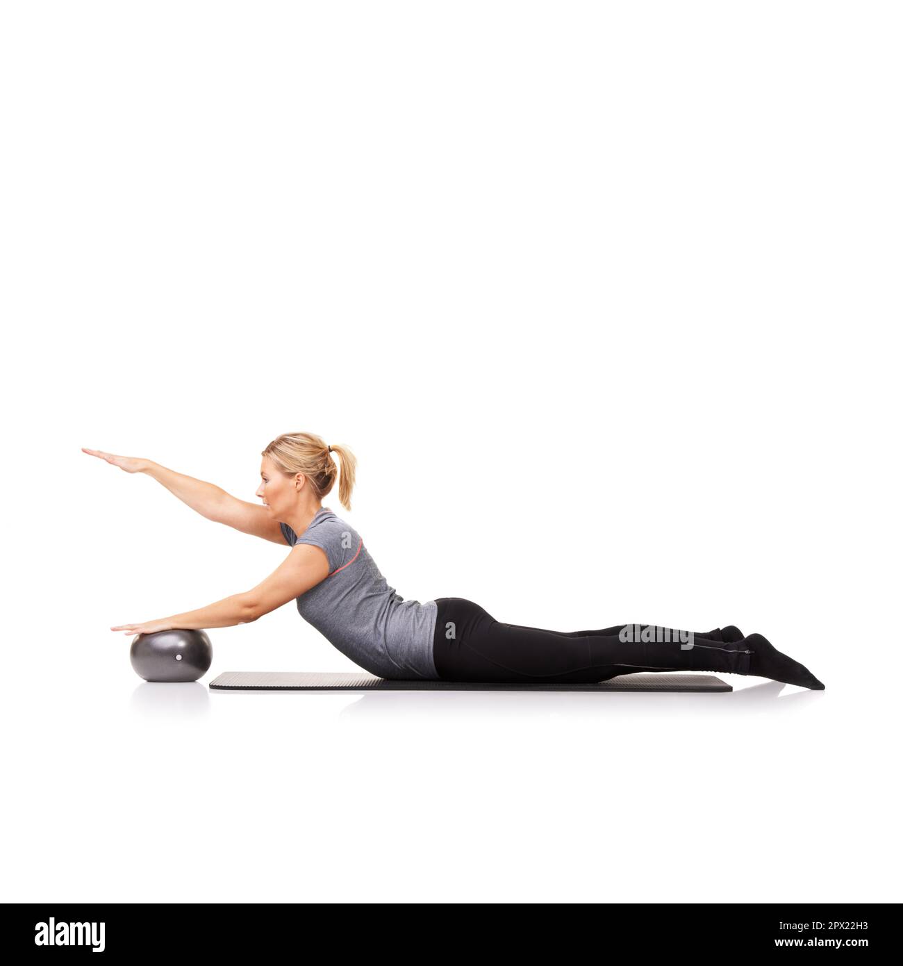 Such a variety of exercises. A young woman using an exercise ball while ...
