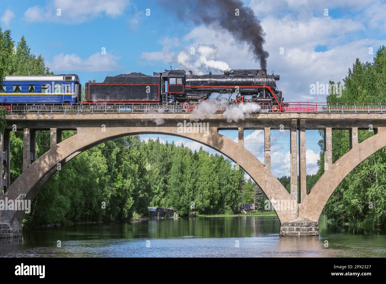Retro steam train moves above the river Stock Photo - Alamy