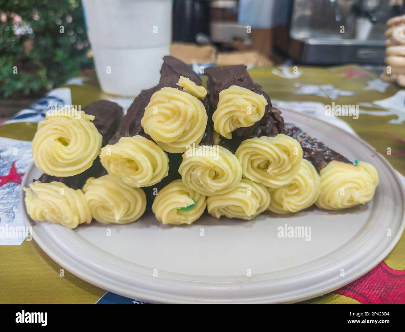 Chocolate coated churros with cream filling. Spanish churros ready to ...