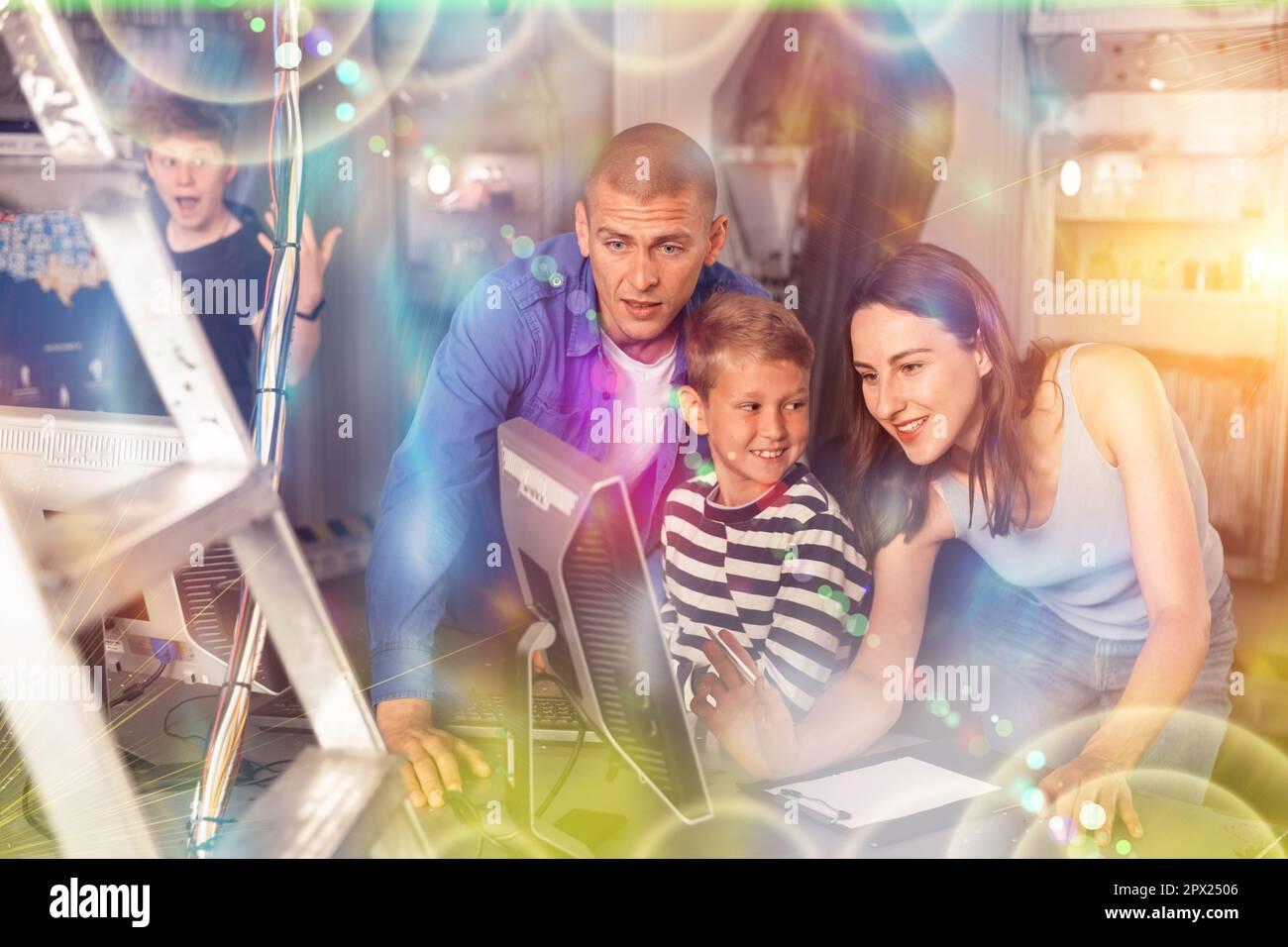 Happy family using computer in closed escape room stylized as bunker ...