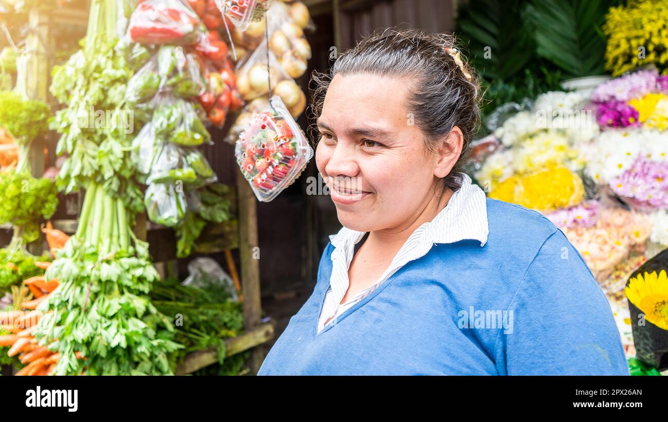 Woman selling fruits and vegetables in front of her stretch on the ...