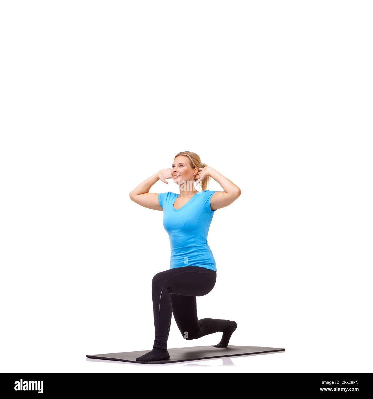 Lunges. A young woman performing a routine on her exercise mat while ...
