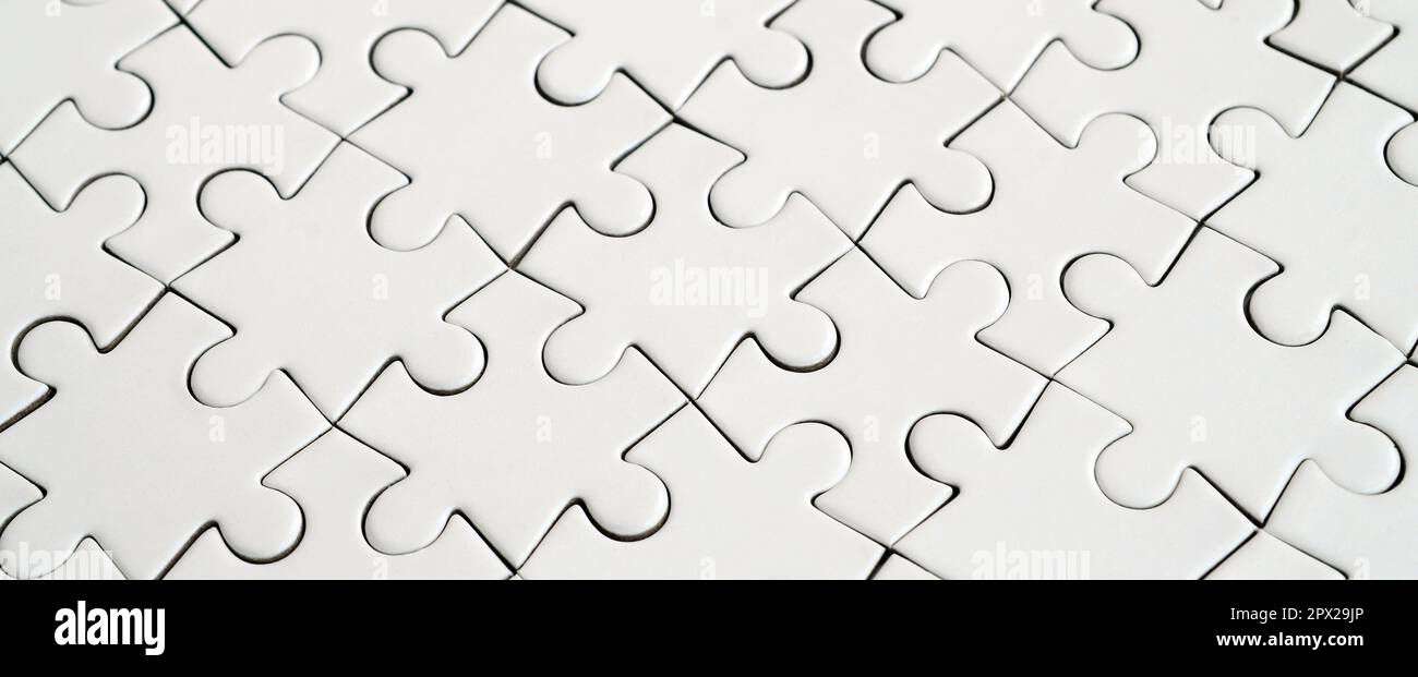 Close up of a white jigsaw puzzle in assembled state in perspective ...