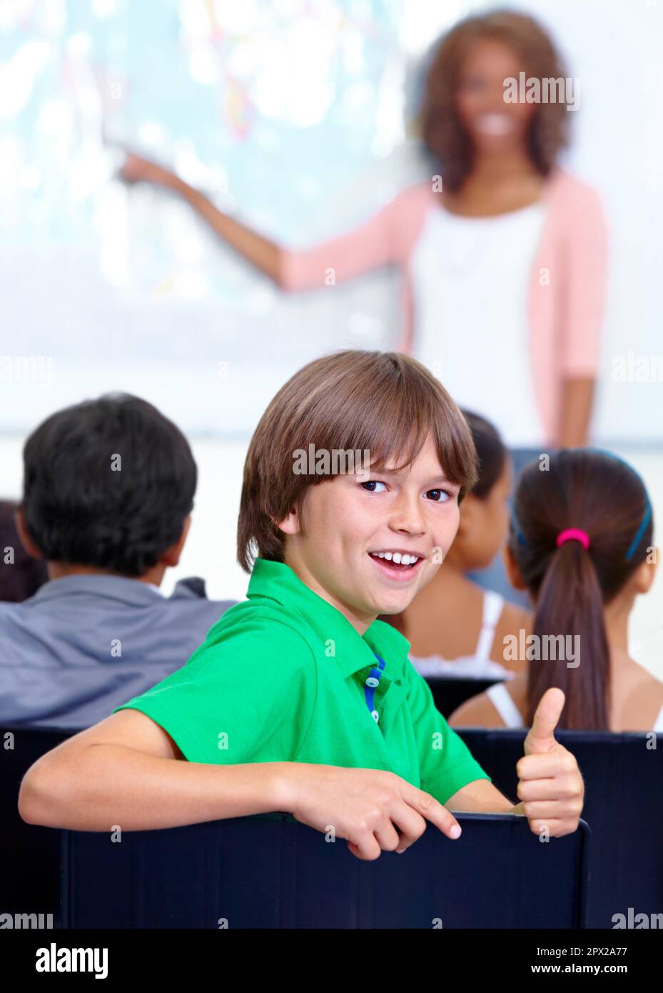 His best subject. Portrait of a young schoolboy giving you thumbs up in ...