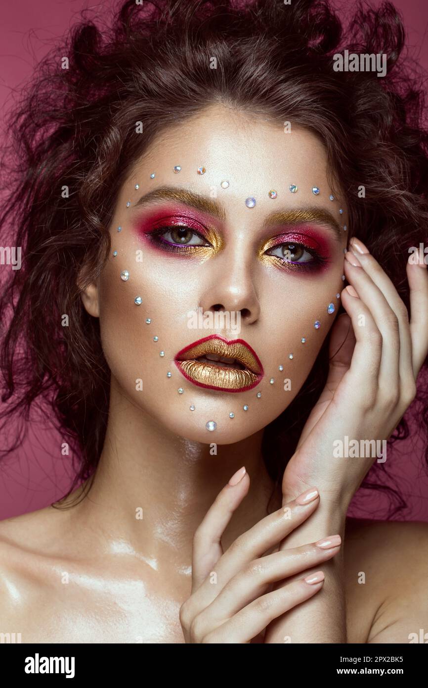 Beautiful girl with bright fashion make-up, and heart from crystals on ...