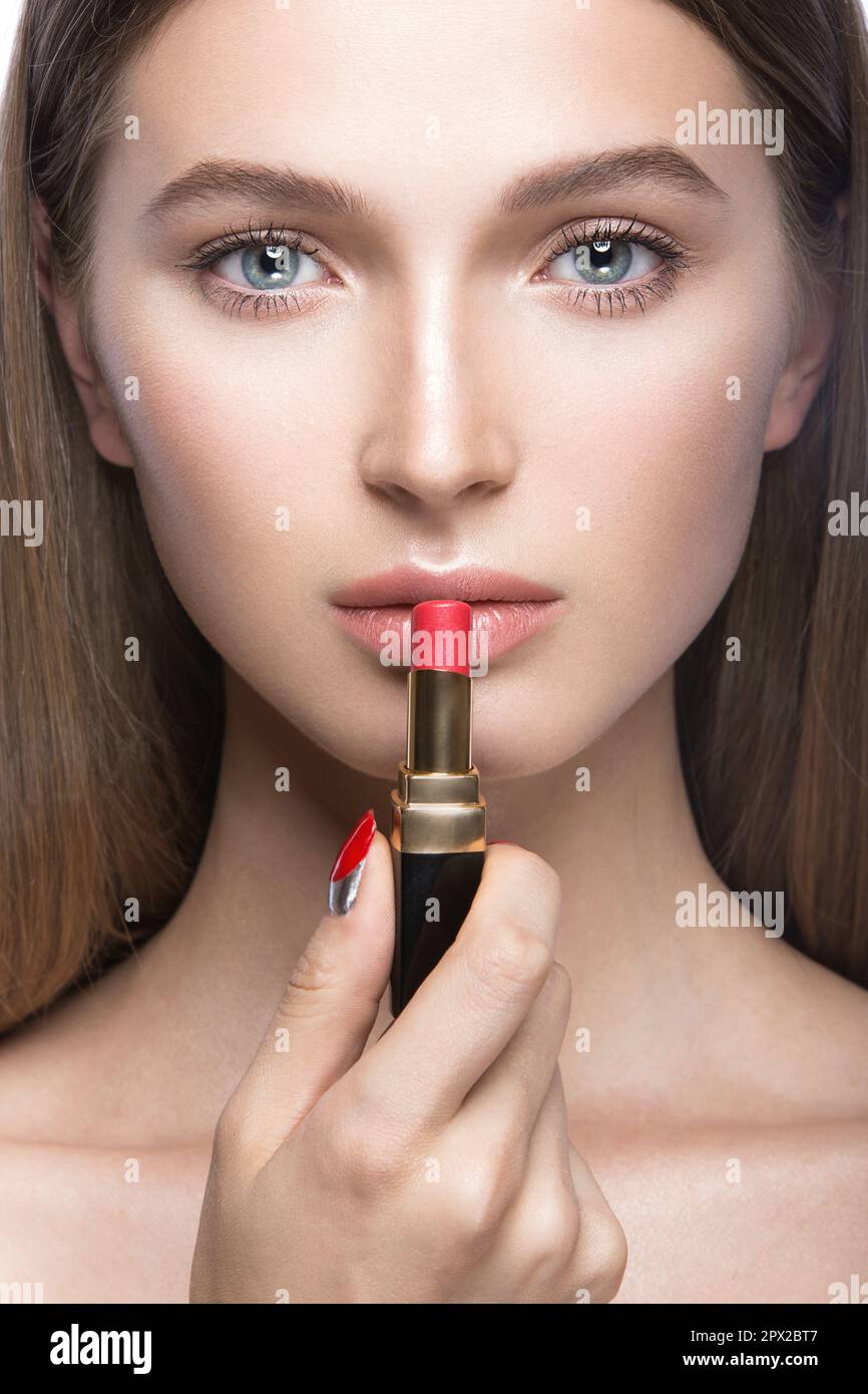 Beautiful young girl with a light natural make-up and beauty tools in ...