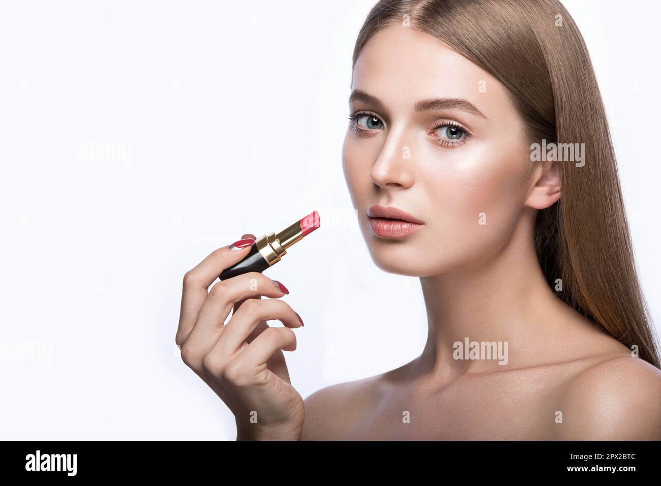 Beautiful young girl with a light natural make-up and beauty tools in ...