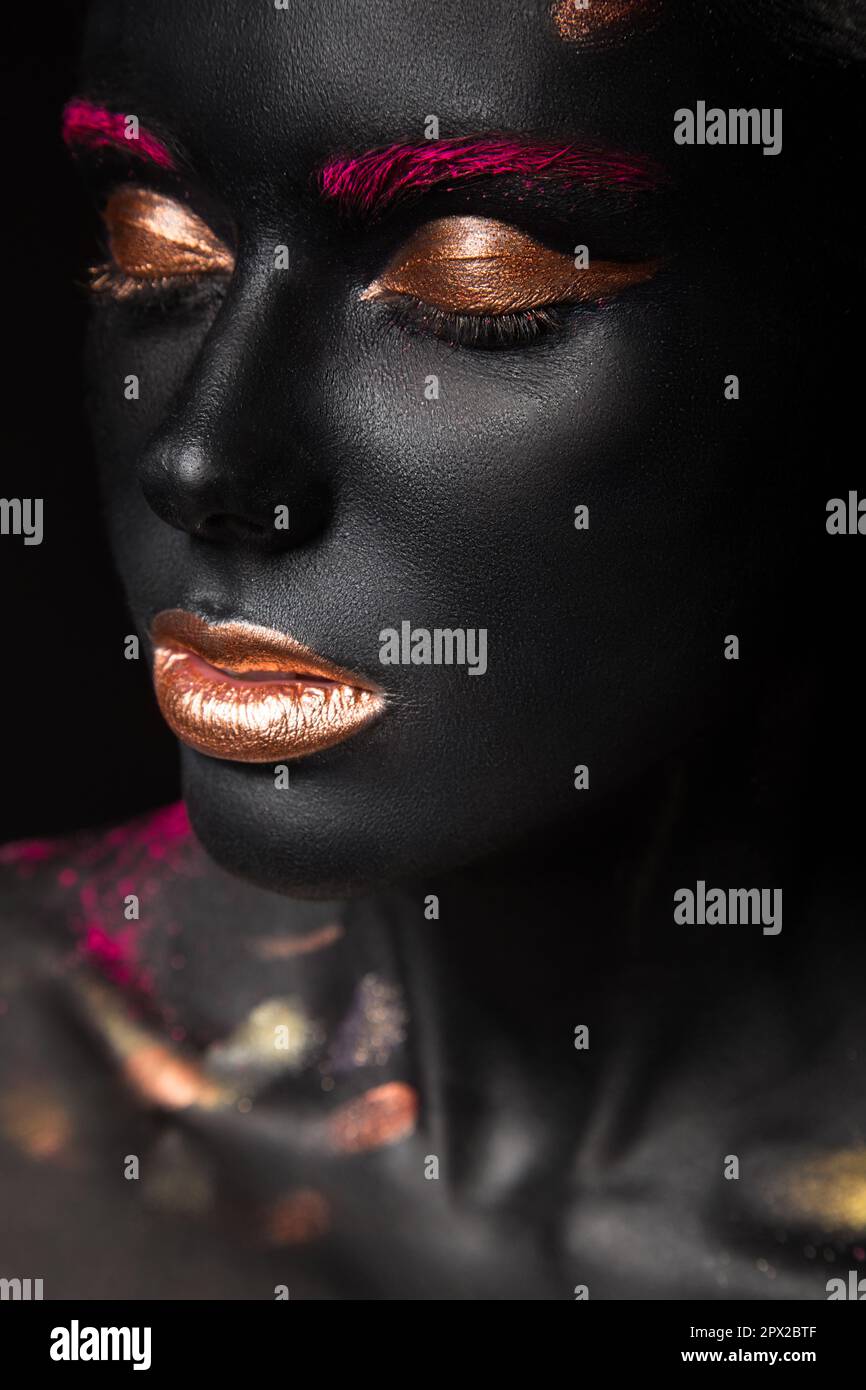 fashion portrait of a dark-skinned girl with color make-up.Beauty face ...