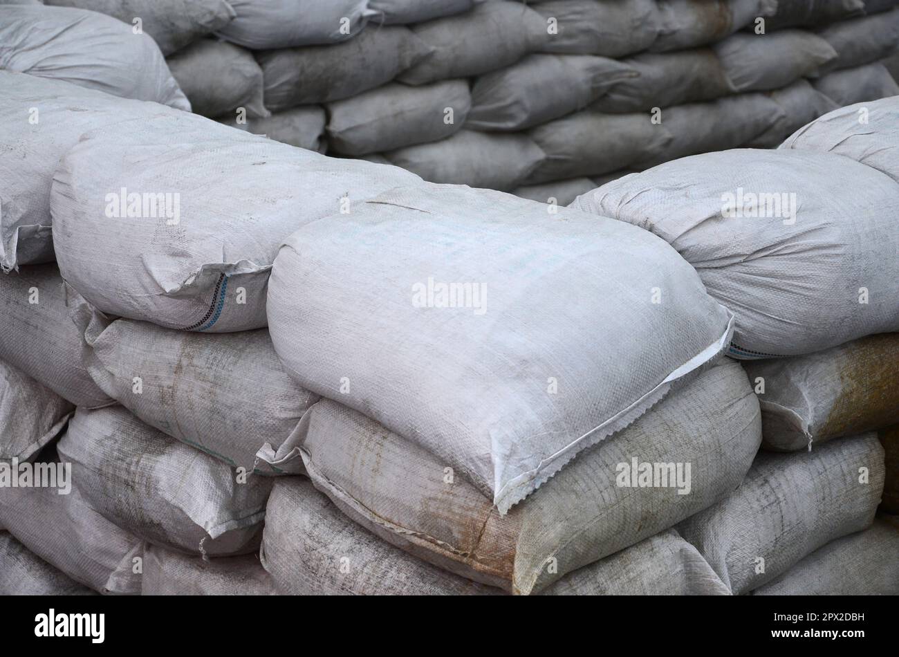 Background of many dirty sand bags for flood defense. Protective ...