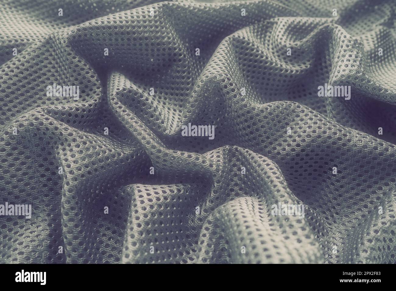 Synthetic fabric with holes laid in waves. Beautiful drape. Fabric for ...