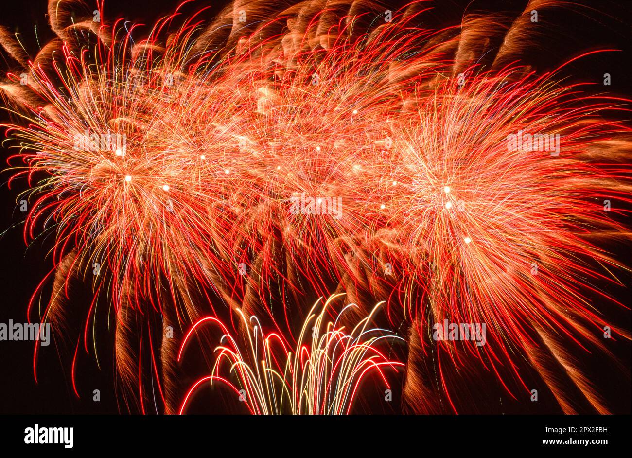 A colorful high-altitude fireworks display in the night sky with ...