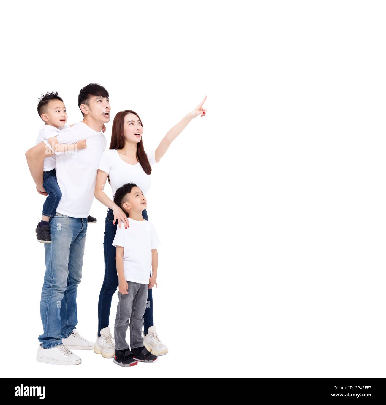 Happy family standing and looking up Stock Photo - Alamy